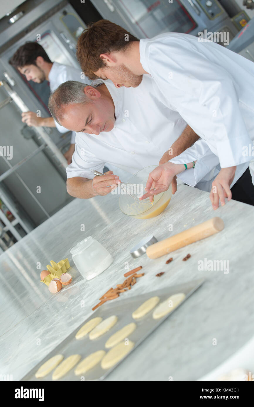 Chefs at work in kitchen Stock Photo - Alamy