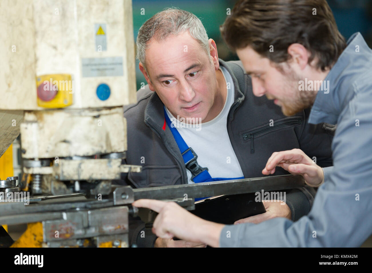 apprentice learning to operate a machine Stock Photo - Alamy