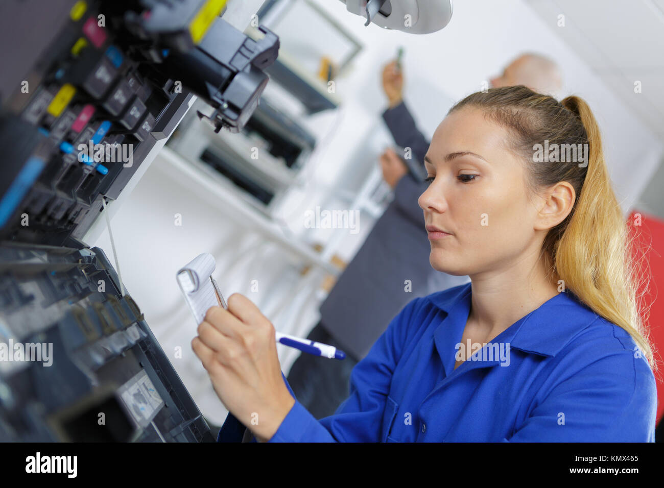 Technician checking photocopier Stock Photo - Alamy