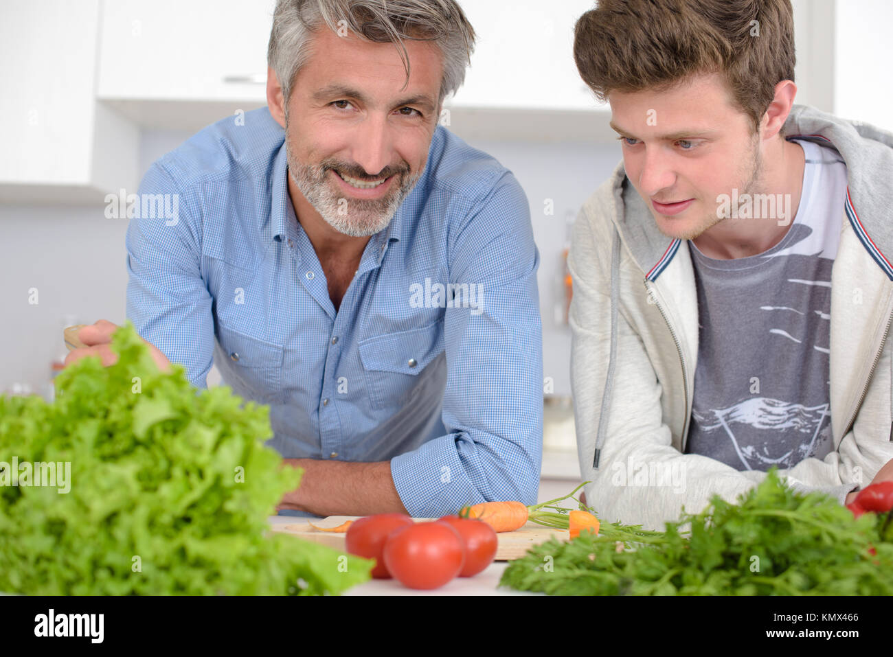 father and son cooking together in kitchen Stock Photo - Alamy