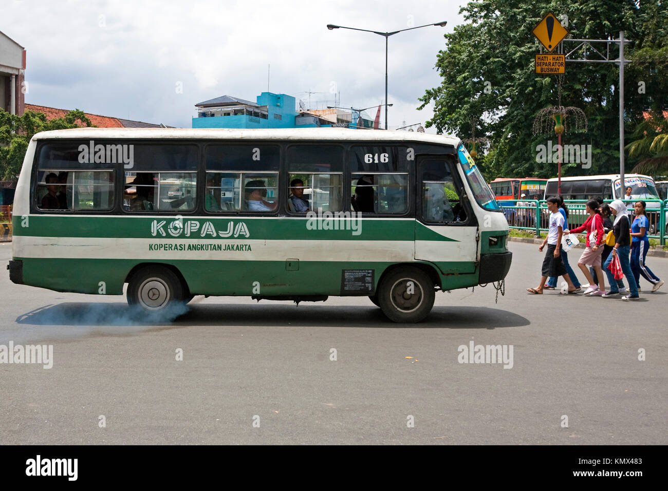 Bus exhaust, pollution and pedestrians, Blok M bus station, Jakarta ...