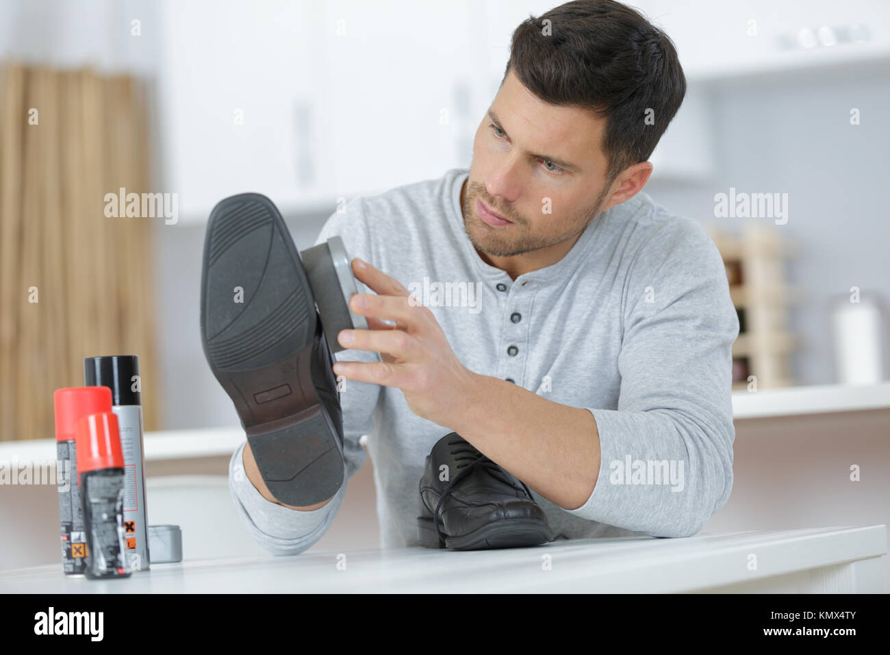 man cleaning combat shoes Stock Photo - Alamy
