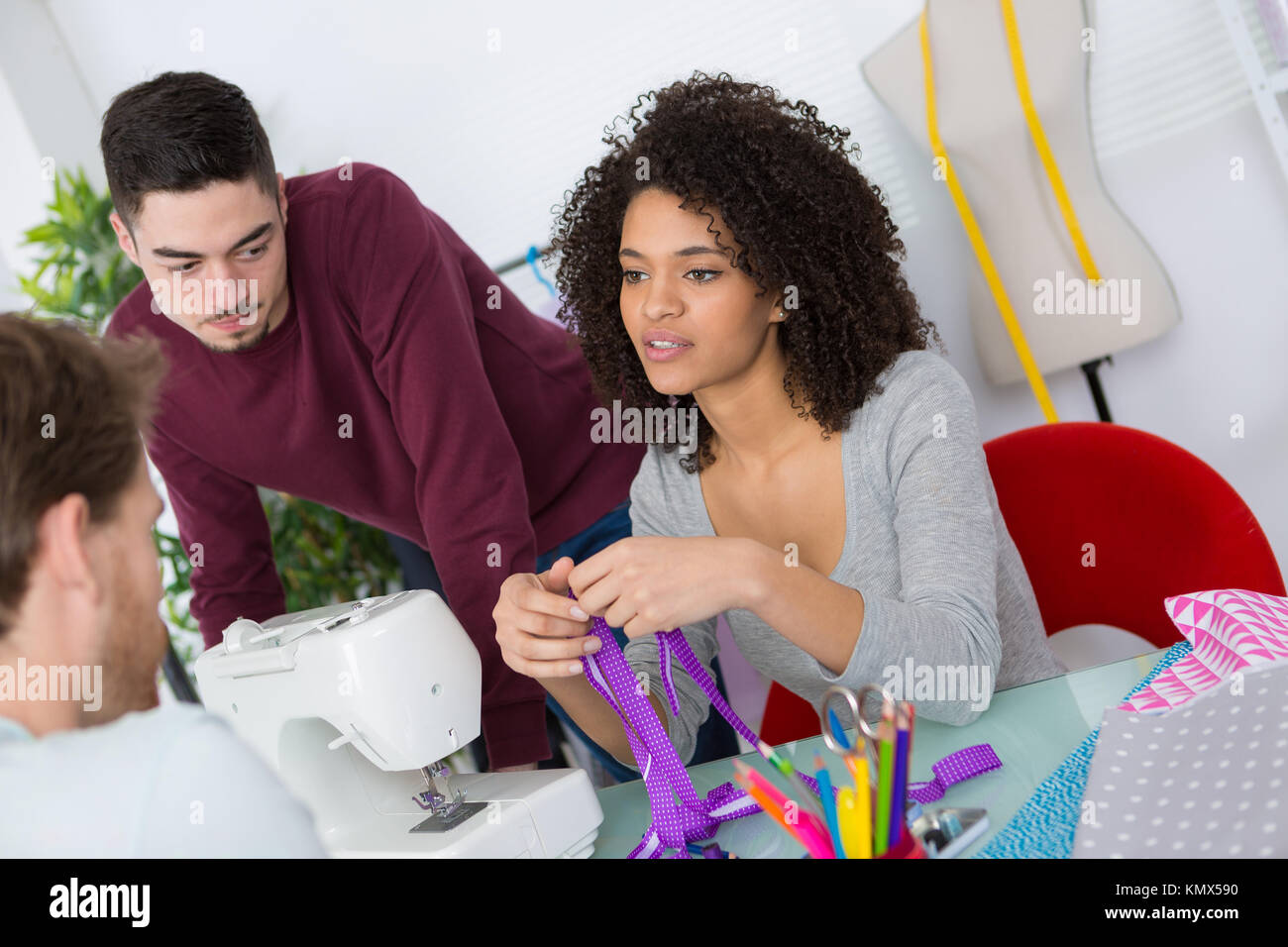 Young people sewing Stock Photo - Alamy