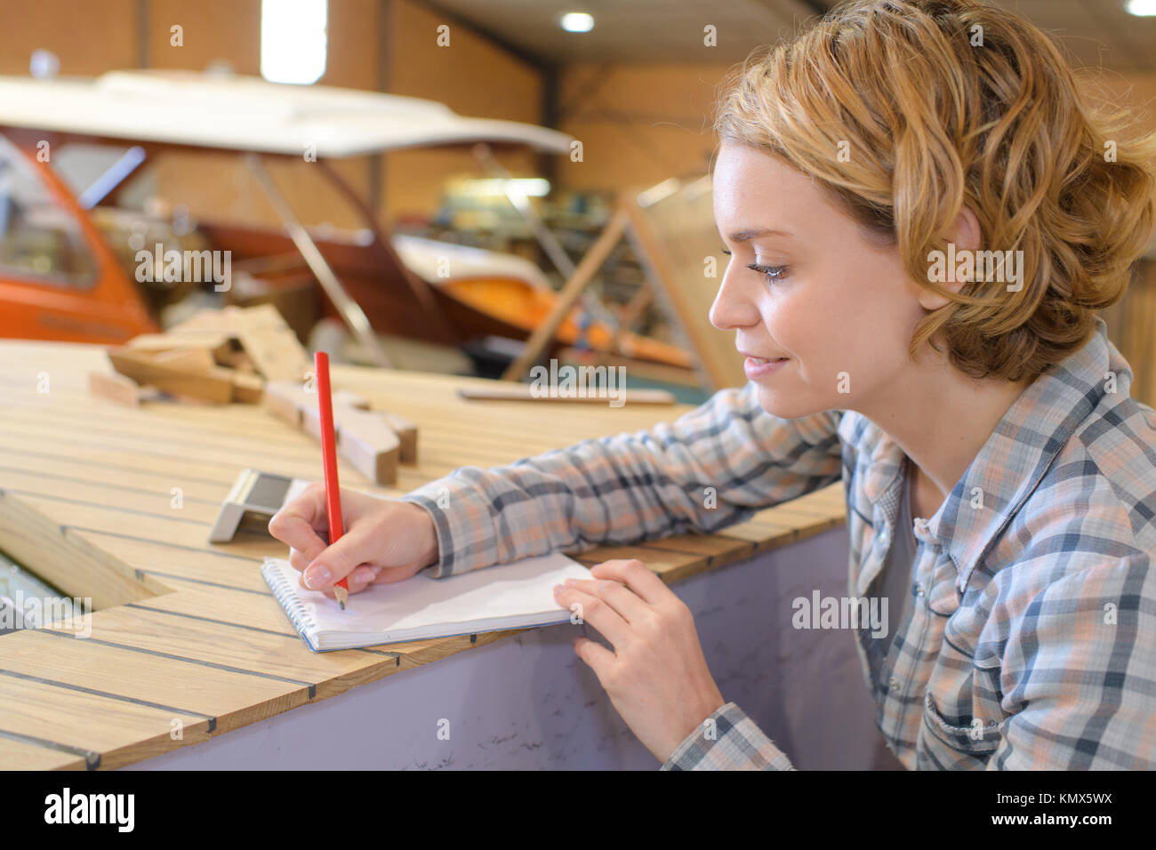 female carpenter making notes Stock Photo - Alamy