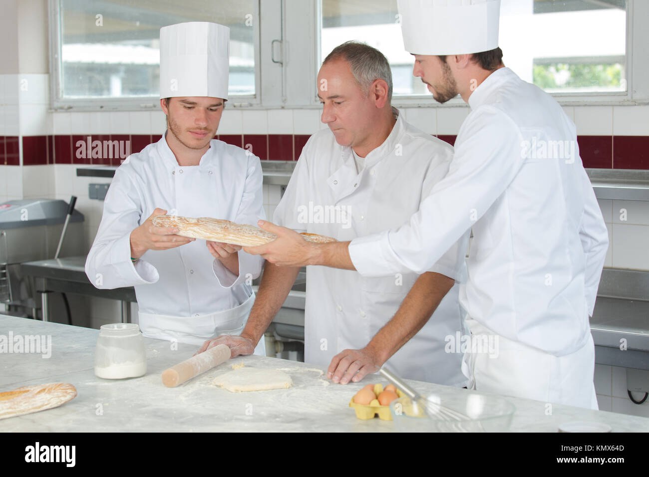 apprentice in bakery making bread with experienced chef Stock Photo - Alamy