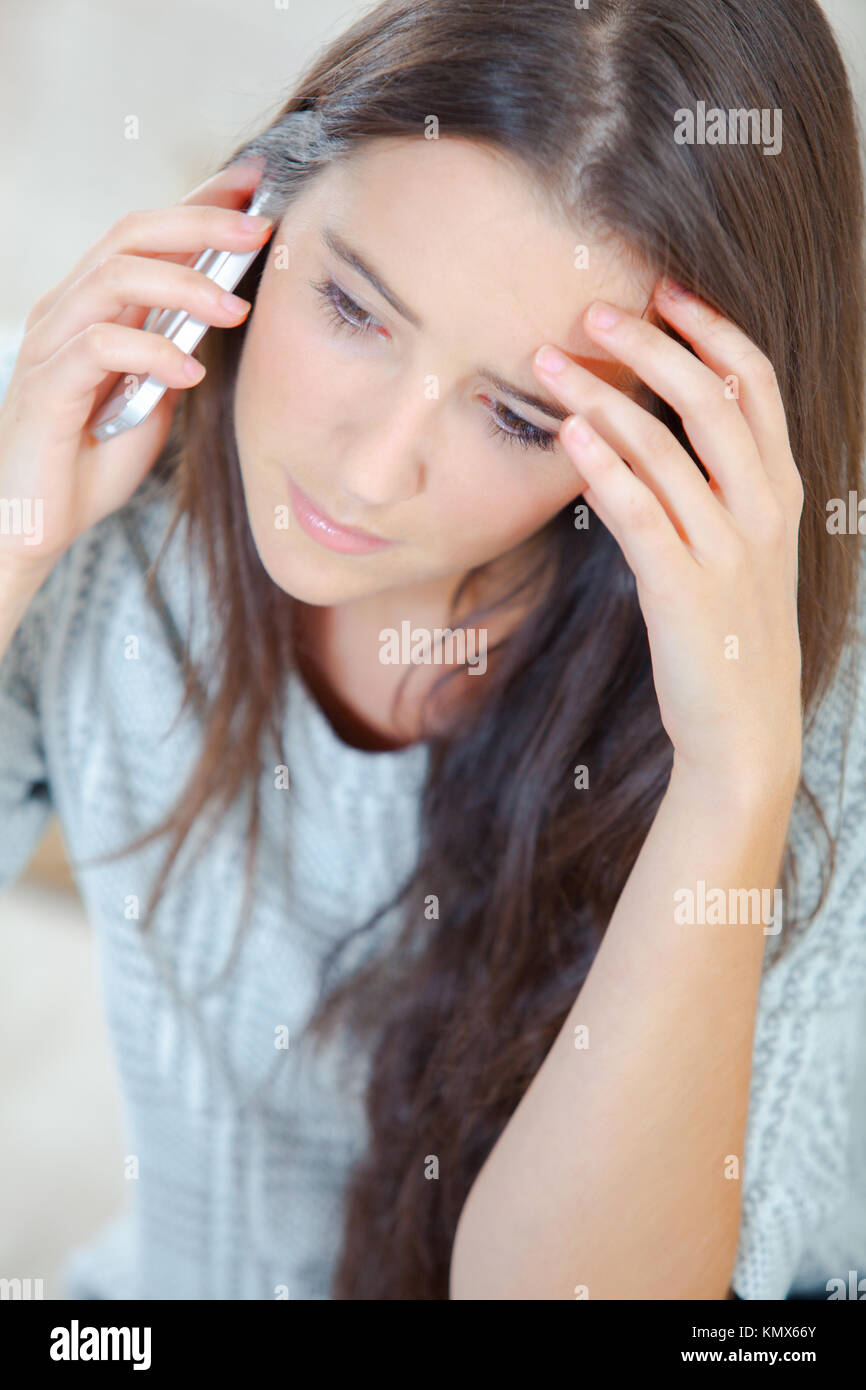 Woman looks worried during phone call Stock Photo - Alamy