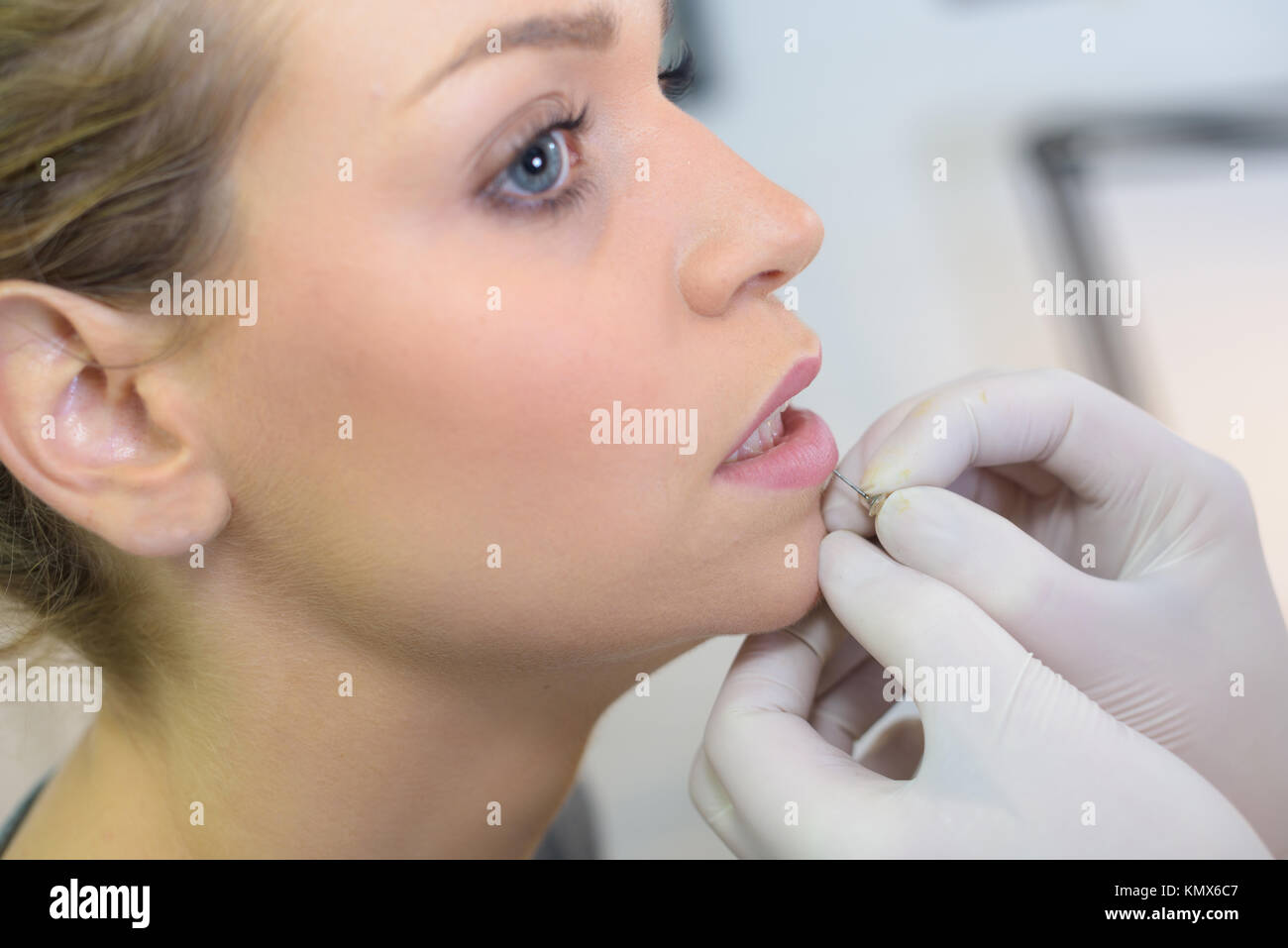 girl getting a piercing Stock Photo - Alamy