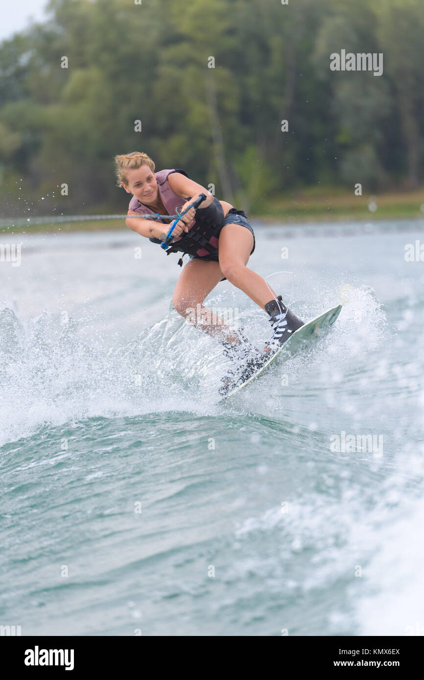 female wakeboarder making tricks on a lake Stock Photo - Alamy