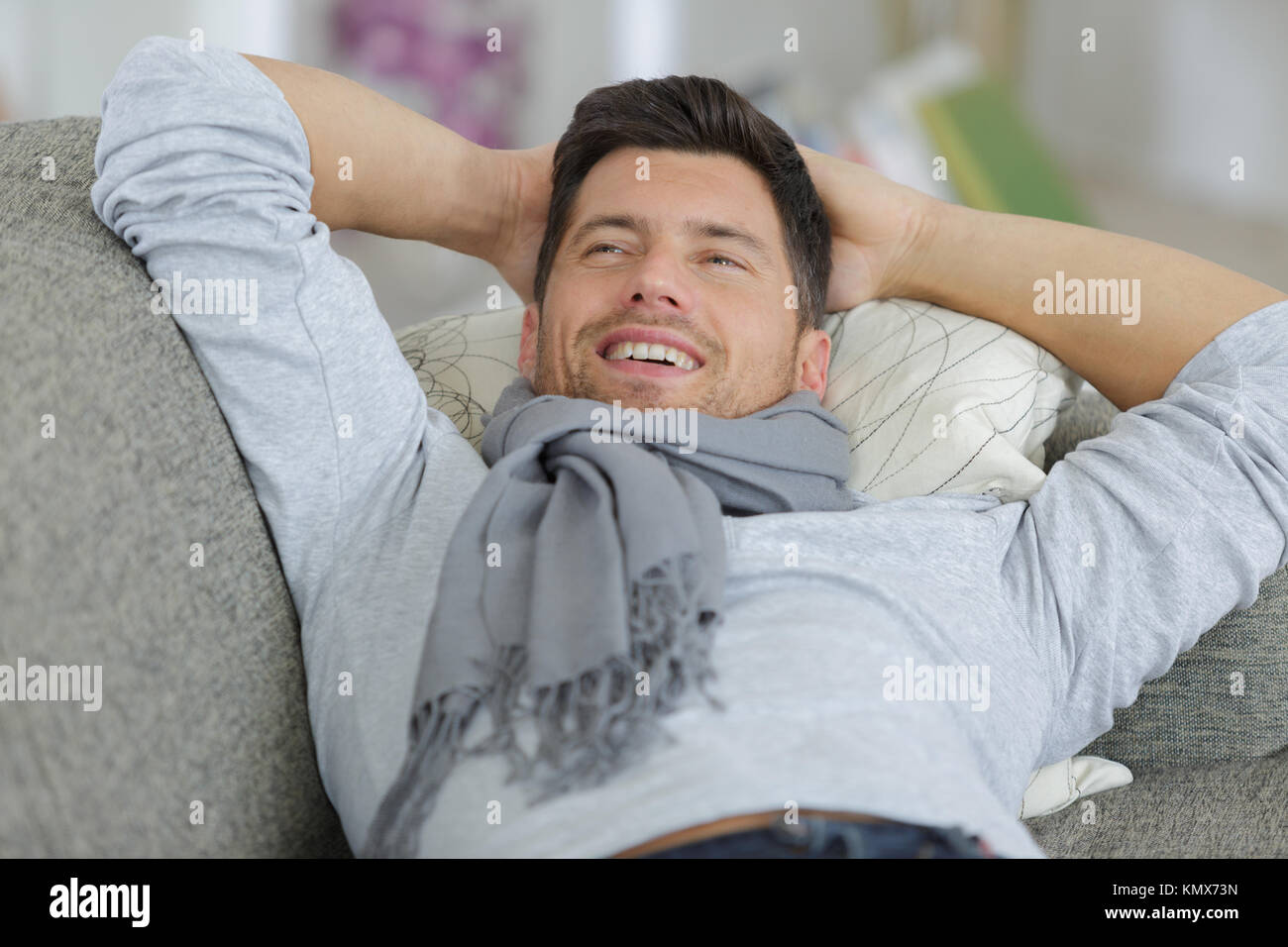 happy man relaxing on sofa at home Stock Photo - Alamy