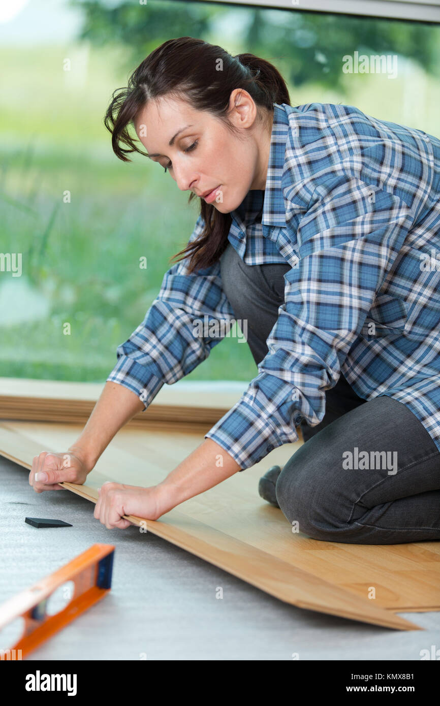 woman using tools to fit floor Stock Photo - Alamy