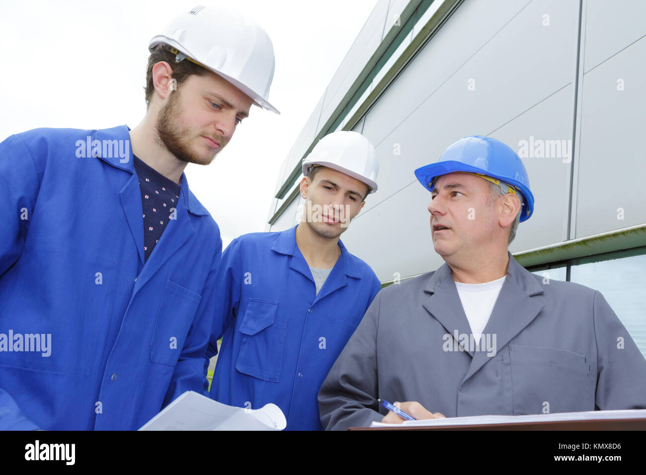team of laborers with the foreman Stock Photo - Alamy