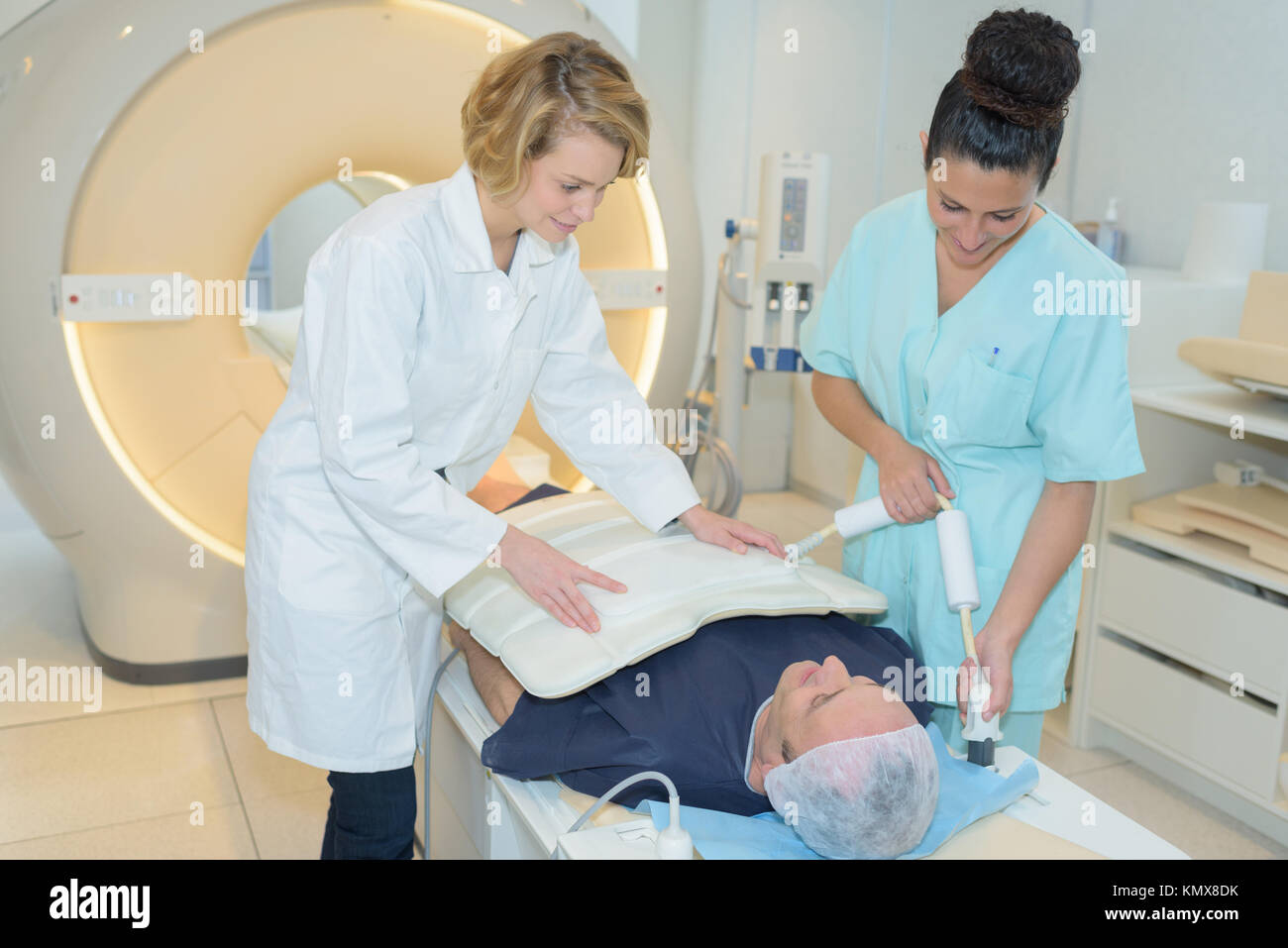 patient undergoes mri scan assisted by two reassuring doctors Stock ...