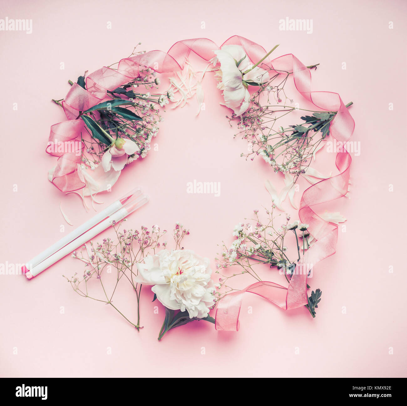 Round floral frame arrangement with pastel pink flowers, markers and ...