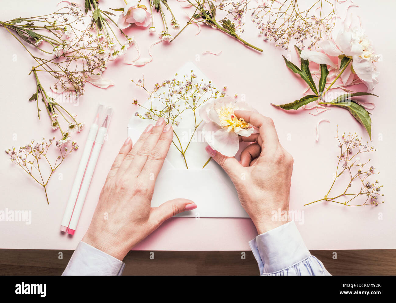 Female hands making lovely floral arrangement with flowers in opened ...