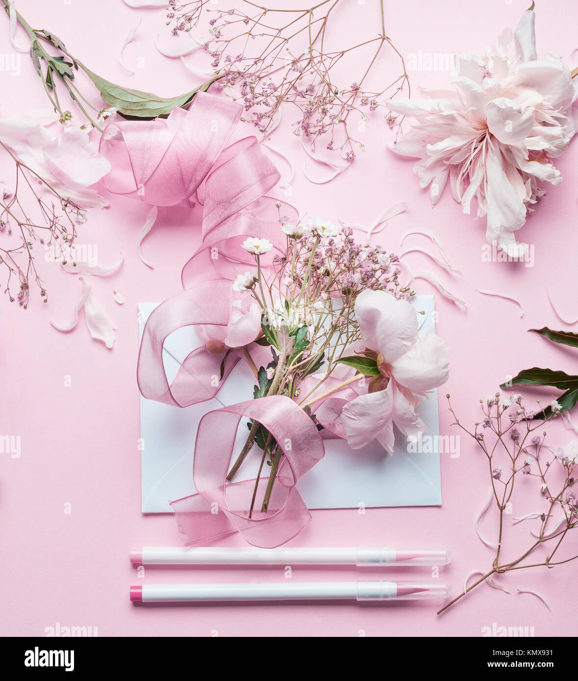 Lovely pink Florist workspace. Beautiful flowers, envelop ,ribbon and ...