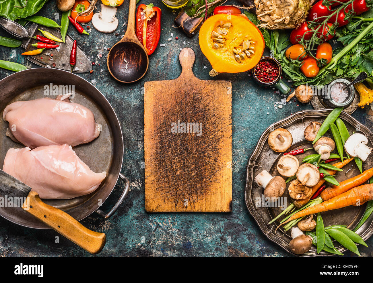 Autumn cooking with organic harvest vegetables, pumpkin and chicken on ...