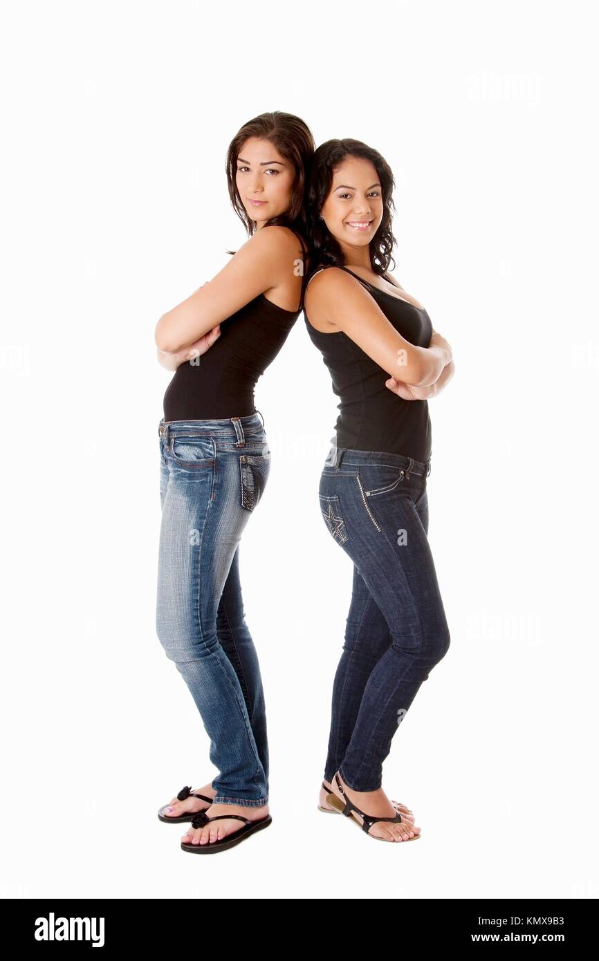 Two beautiful happy smiling young women standing together as a couple ... Two beautiful happy smiling young women standing together as a couple ...
