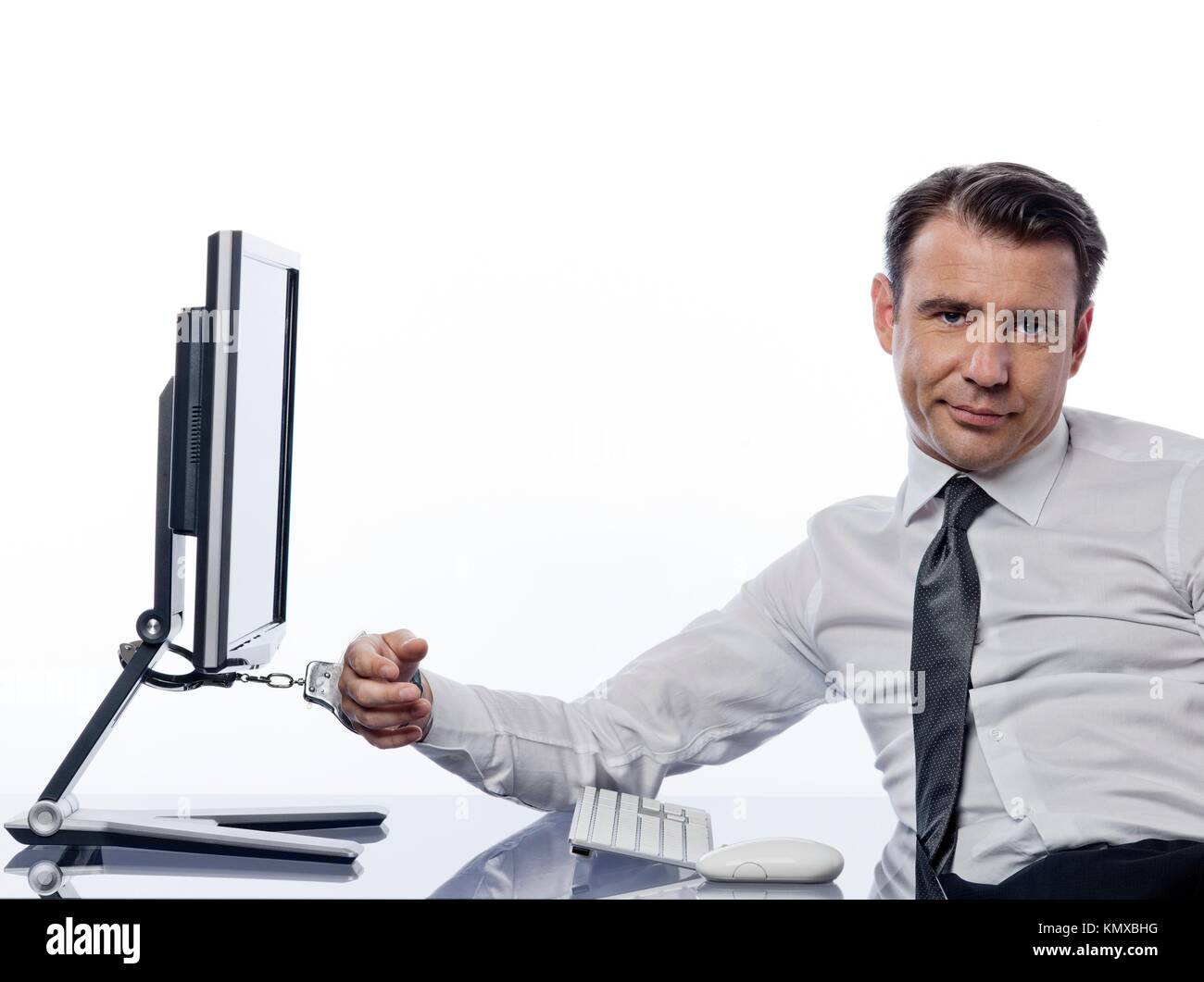 caucasian man chained to computer with handcuffs expressing technology ...