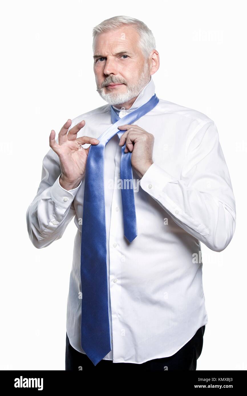 caucasian senior man portrait fixing necktie isolated studio on white ...