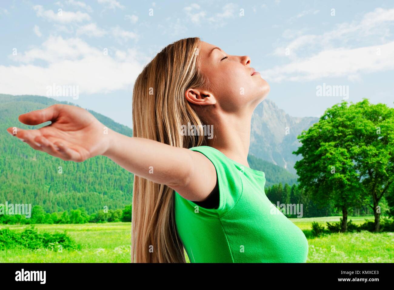 Relaxed young woman with arms outstretched, enjoying nature Stock Photo ...