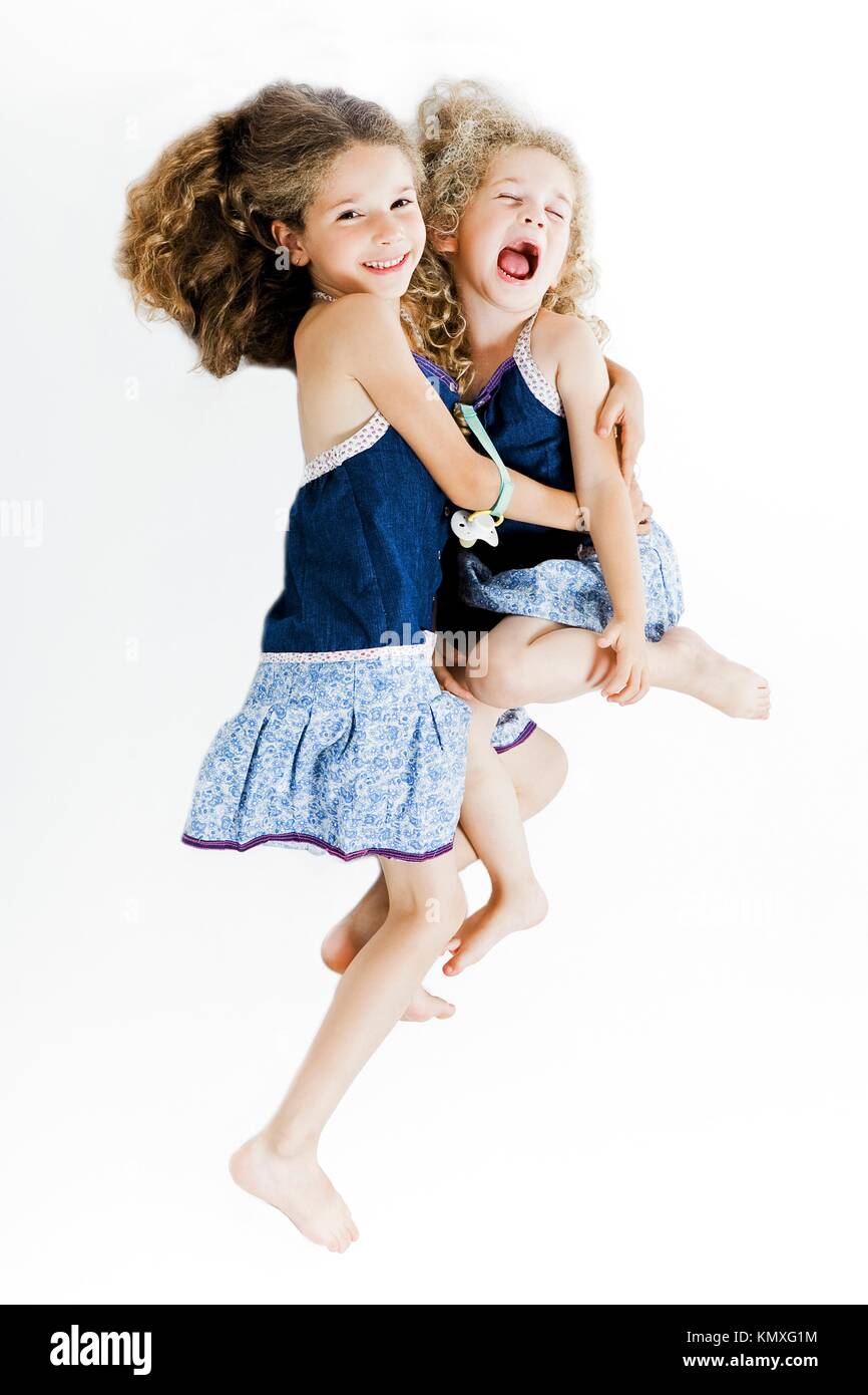 caucasian little girl cheer up hug sister isolated studio on white ...