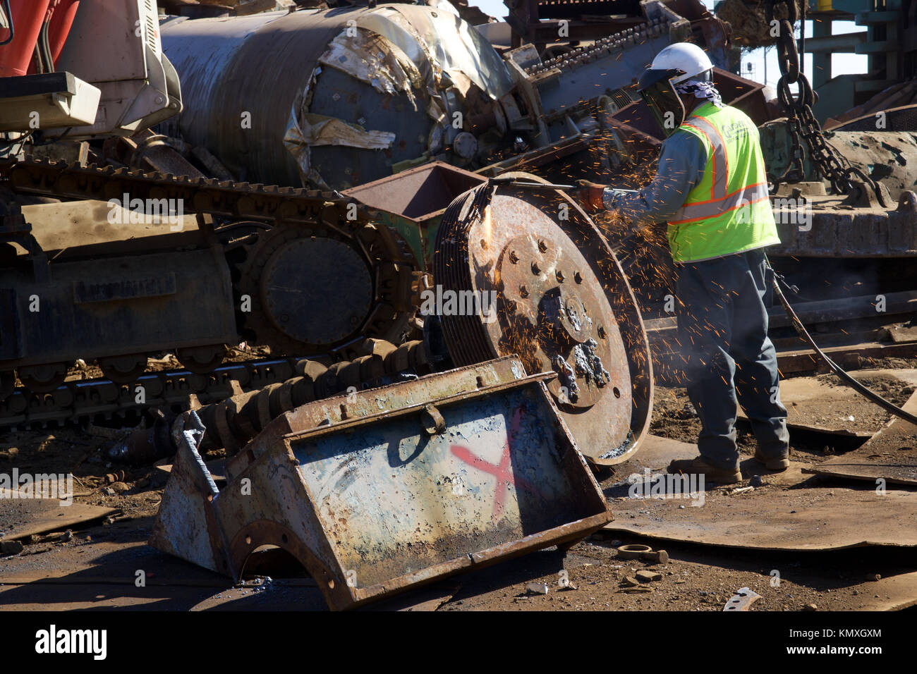 recycling center with bales of metal and crane with claw tossing truck ...