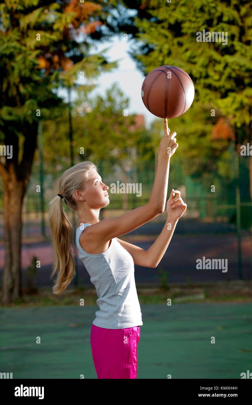 Young athlete spinning basketball Stock Photo - Alamy