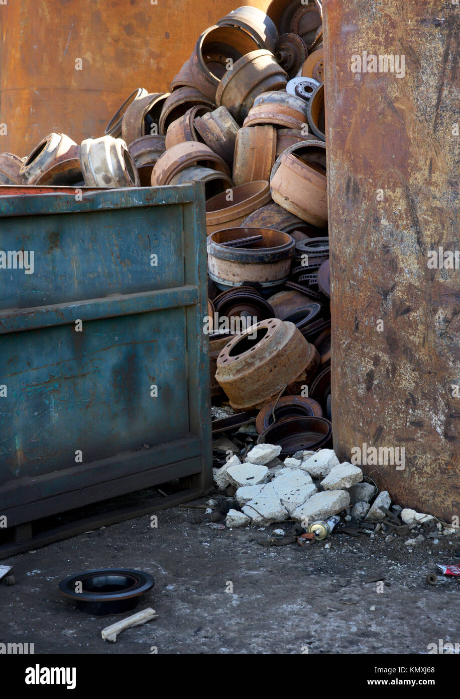 recycling center with bales of metal and crane with claw tossing truck ...