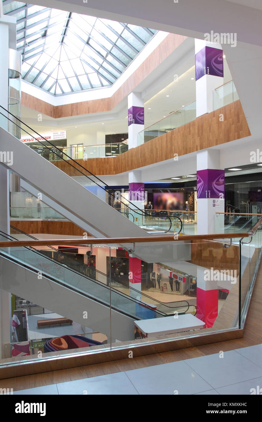 Hall with columns and escalators in huge shopping center. A view of ...