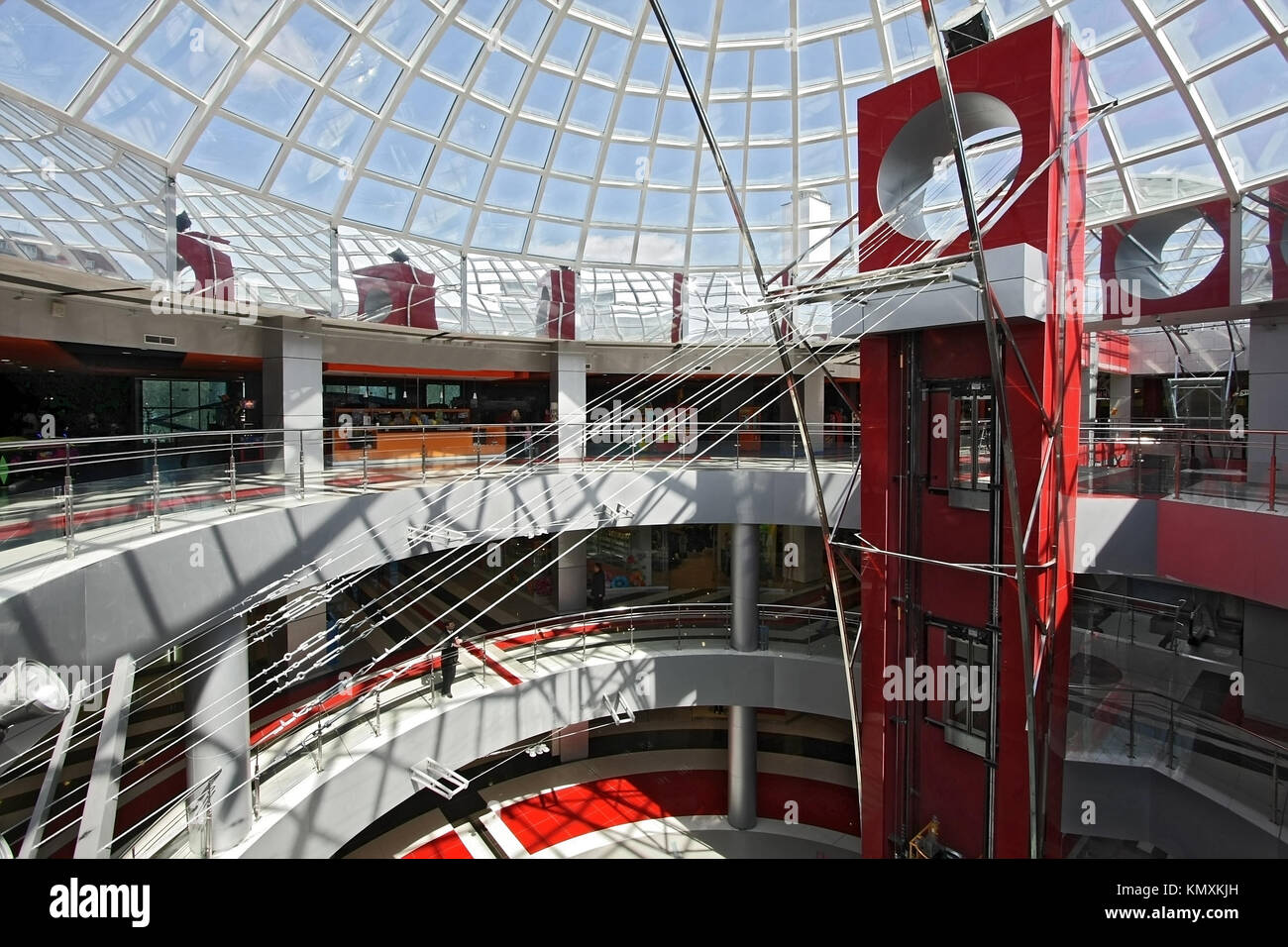 Huge hall of modern shopping centre with the glass lift and a ...