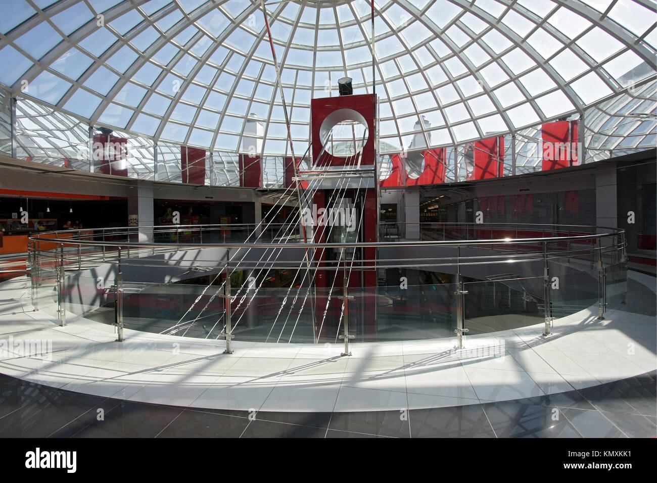 Huge hall of modern shopping centre with the glass lift and a ...