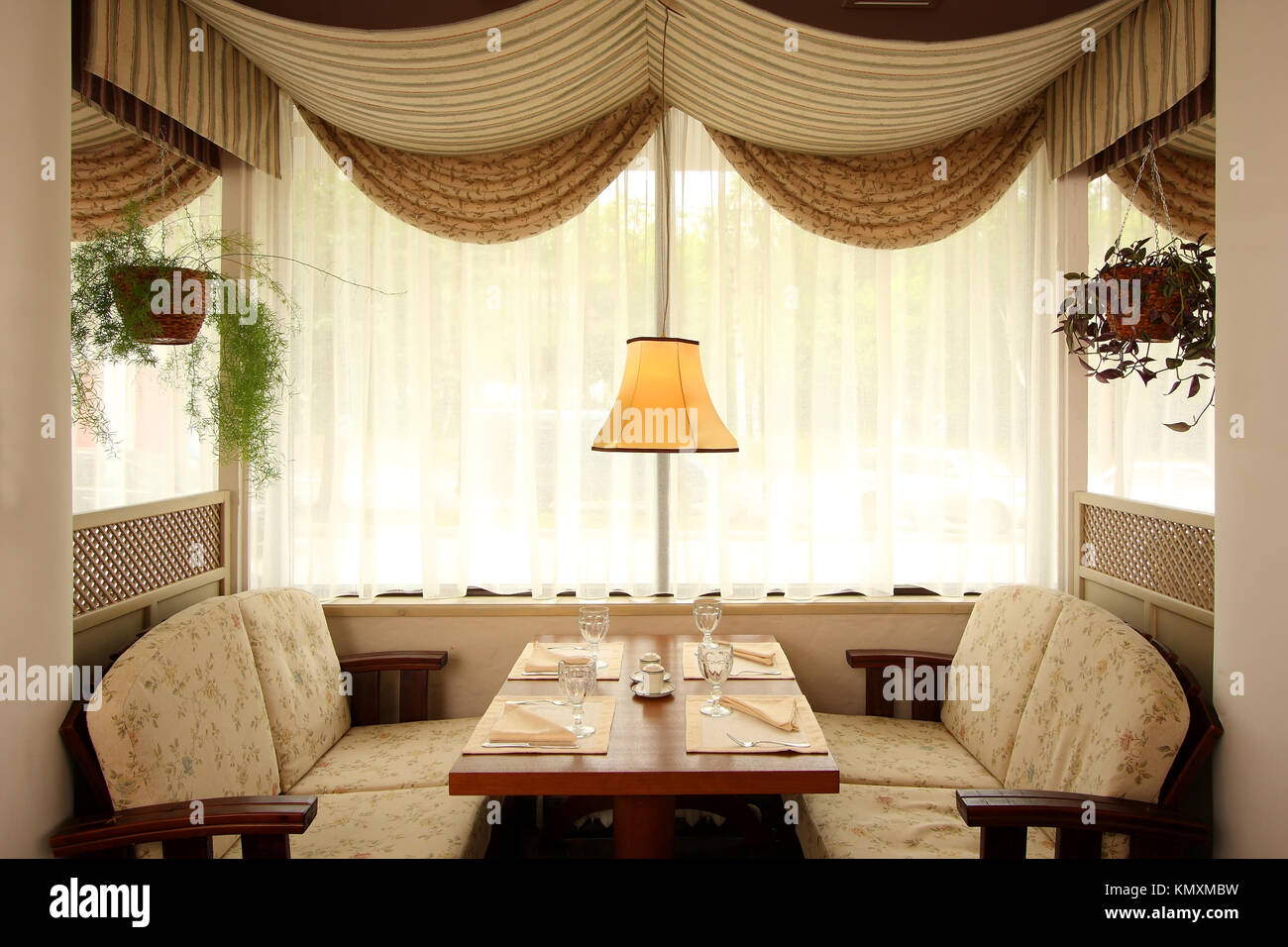 Table at a window at restaurant Stock Photo - Alamy