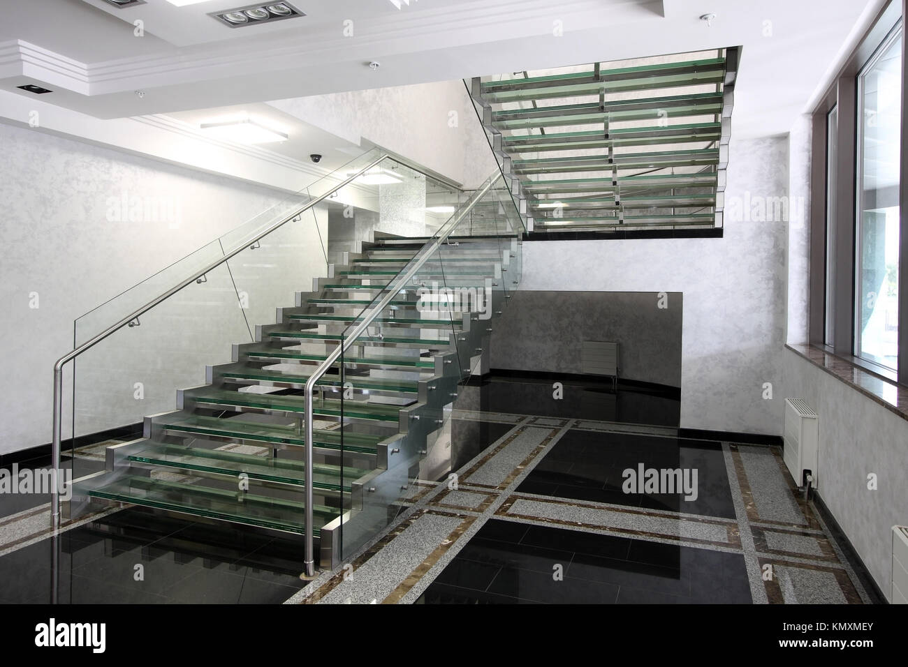 The big ladder from glass in a hall of office building Stock Photo - Alamy