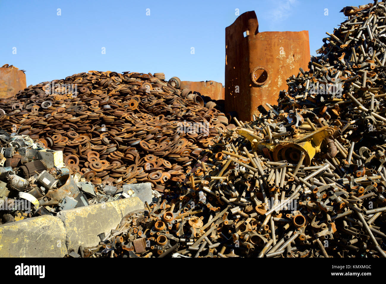 recycling center with bales of metal and crane with claw tossing truck ...