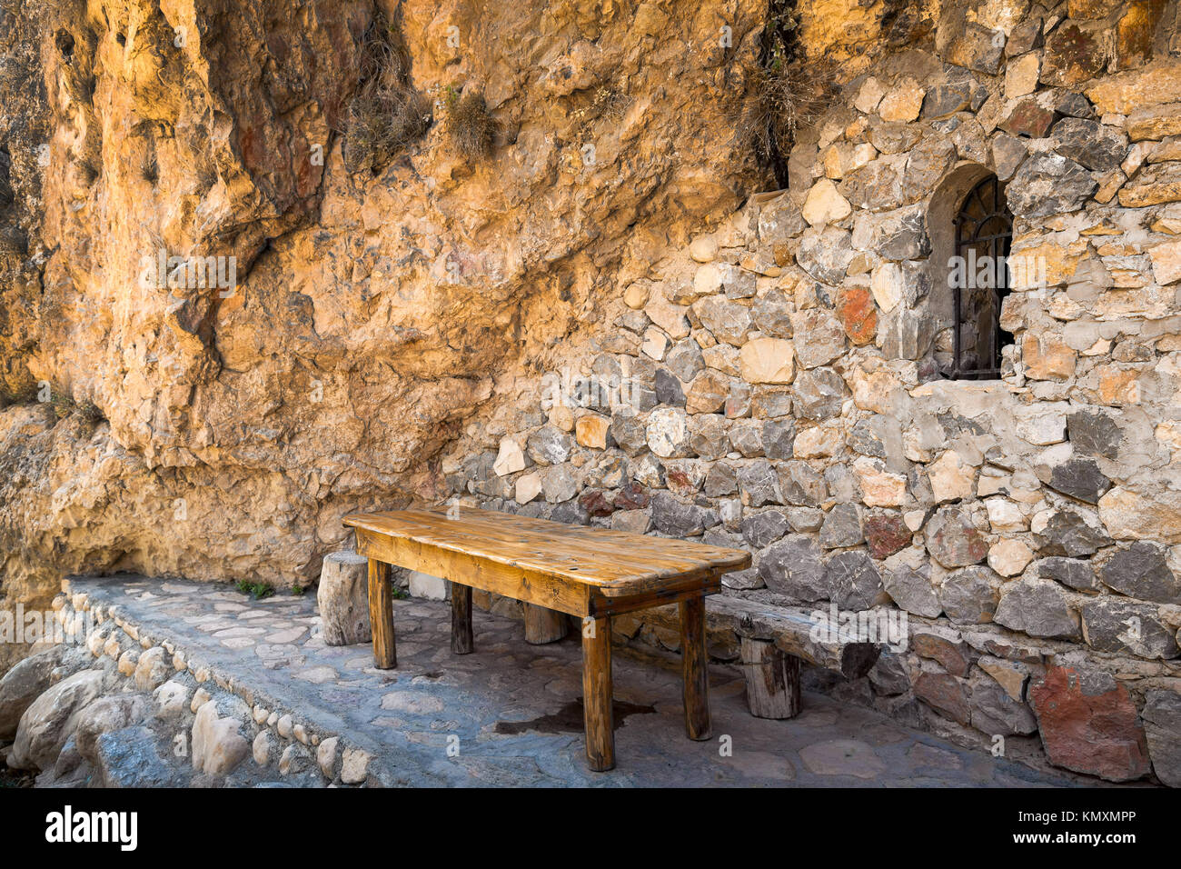 The stone wall with a window closing a grotto in the rock Stock Photo ...