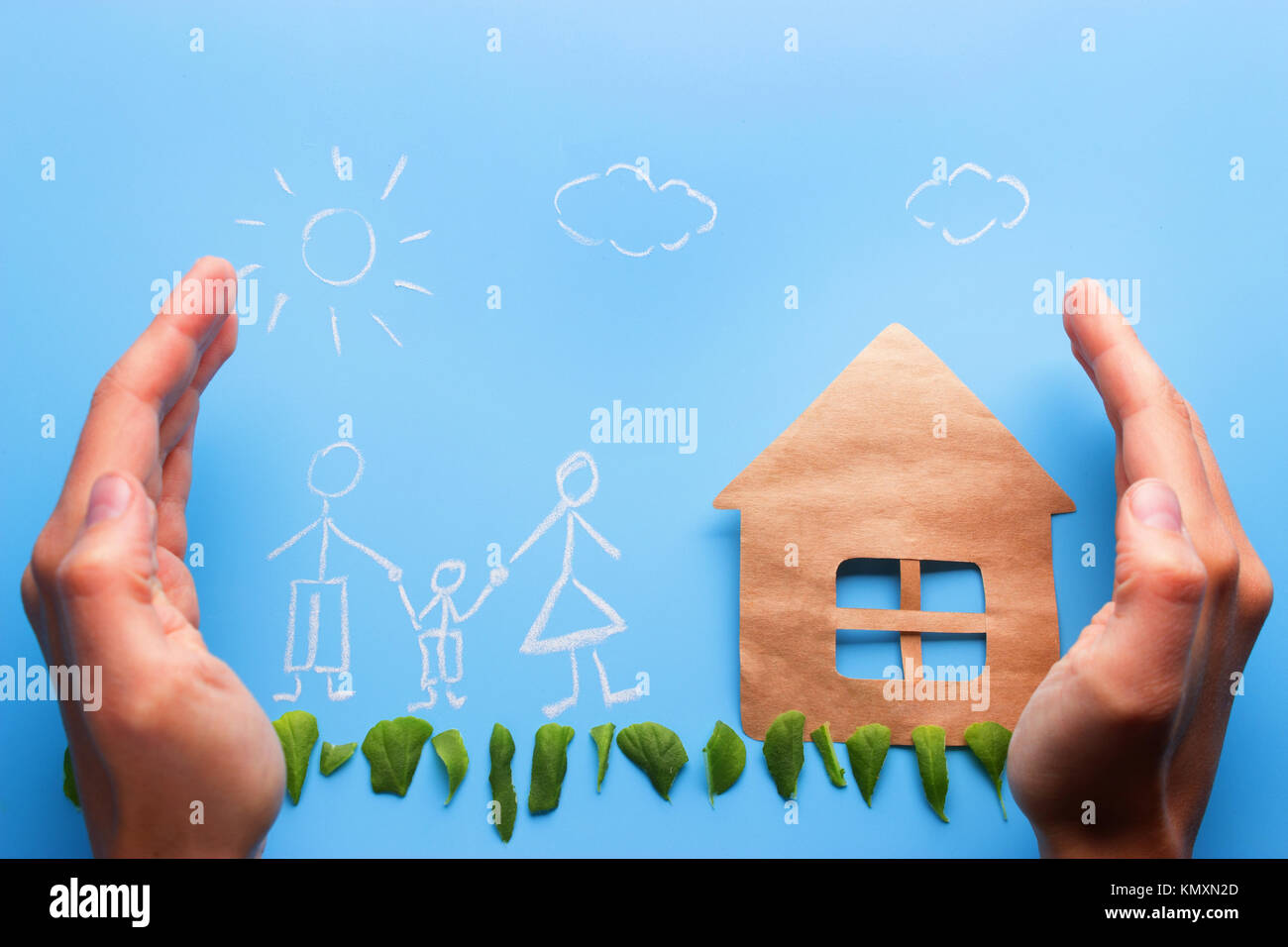 secure family and house concept. family and house protected by hands ...