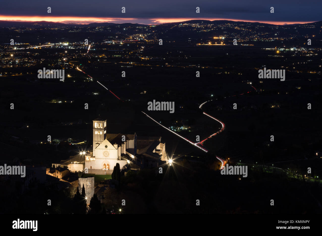 Aerial view of St. Francis papal church in Assisi at night, with city ...