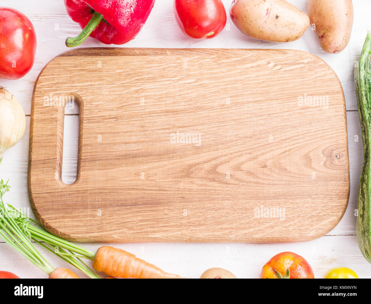 Wooden empty chopping board and vegetables near it Stock Photo - Alamy