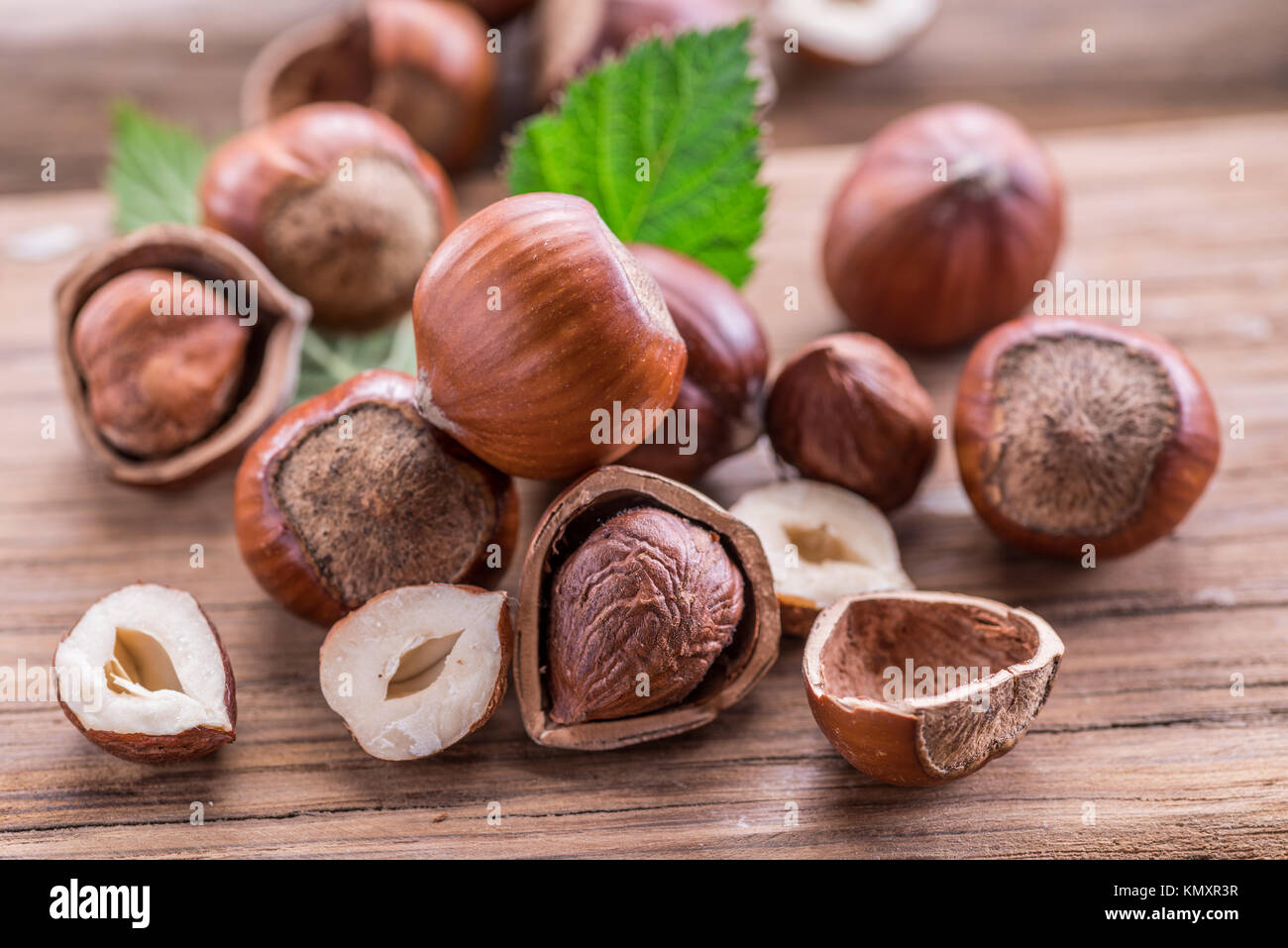 Hazelnuts and hazelnut leaves on the wooden table Stock Photo - Alamy
