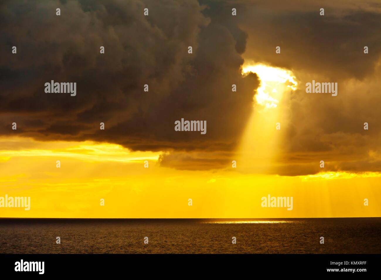 Shining through dark clouds on sea hi-res stock photography and images ...