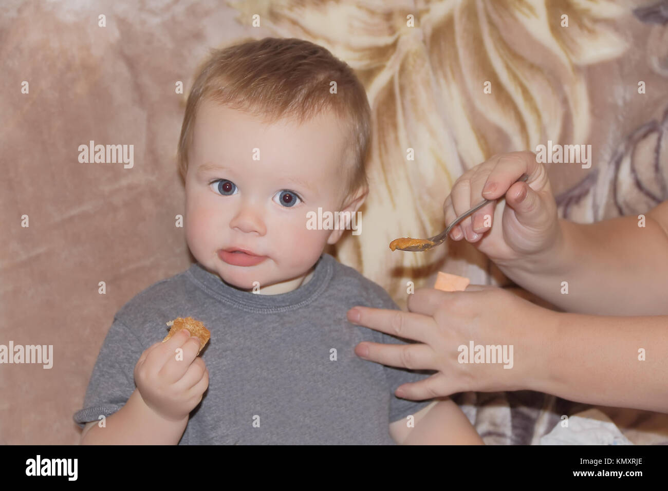 Image of cute baby boy eating bread Stock Photo - Alamy