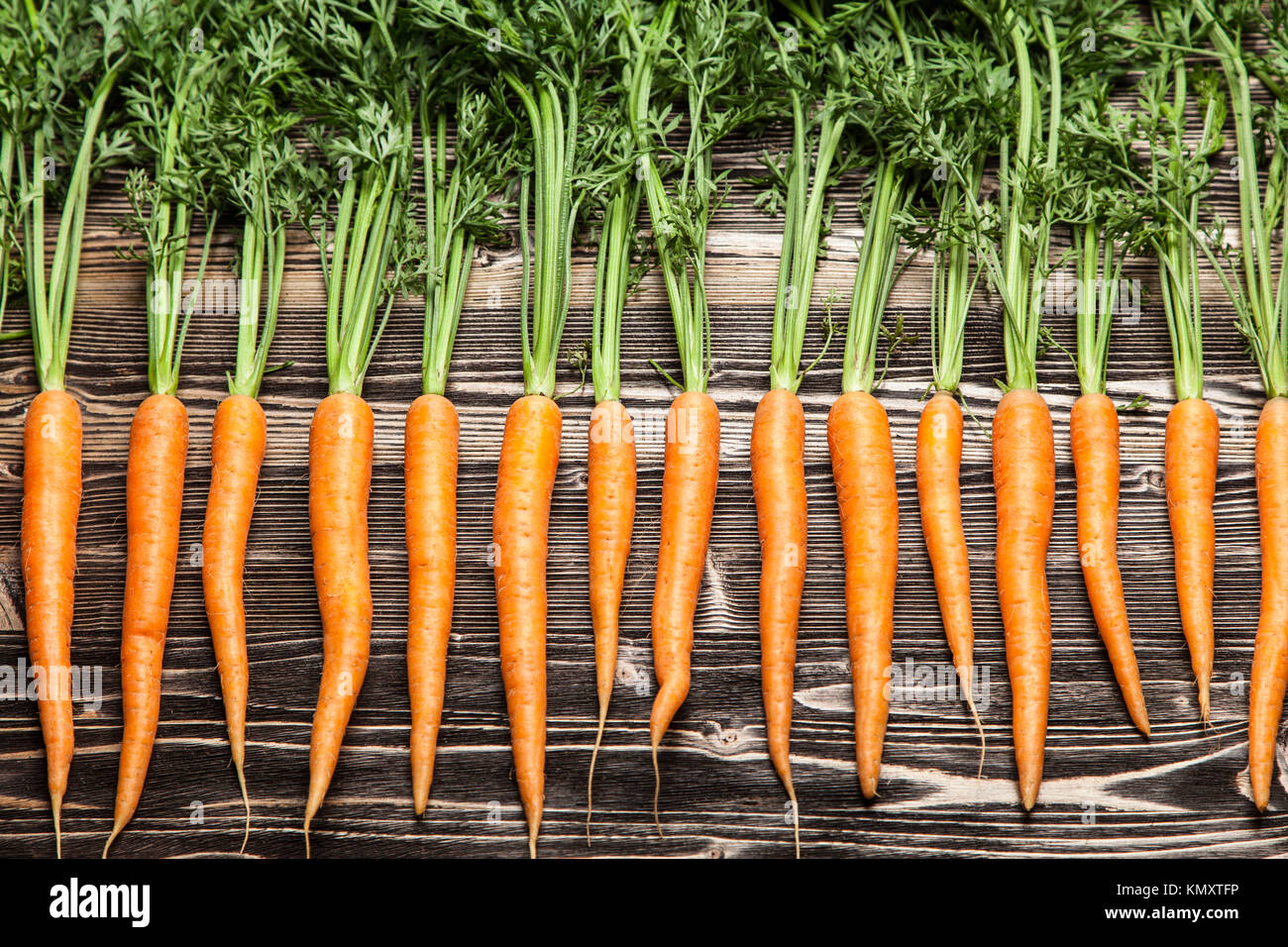 Carrot on wooden table Stock Photo - Alamy