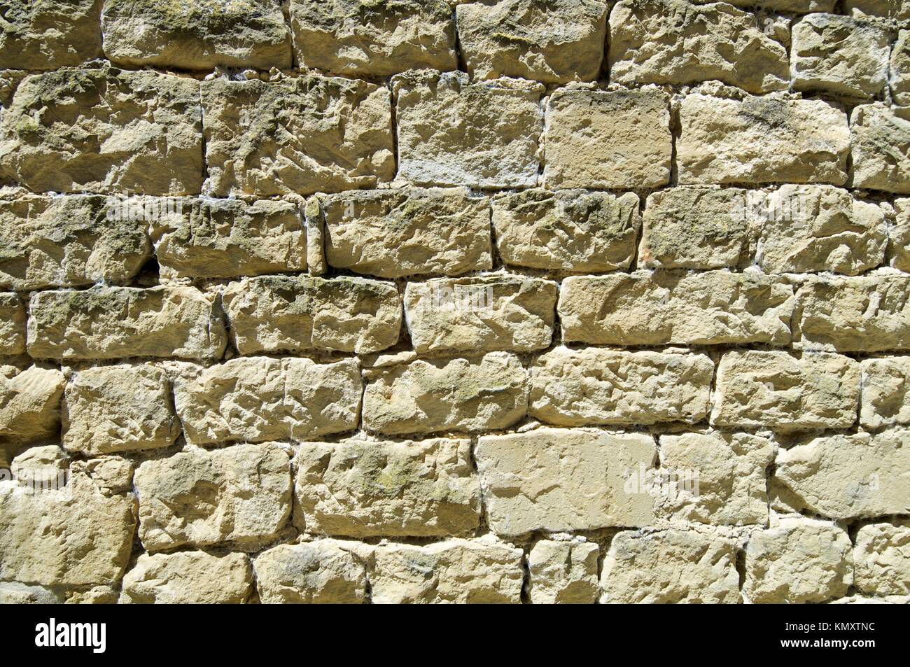front view of an old stone wall with uneven stones Stock Photo - Alamy
