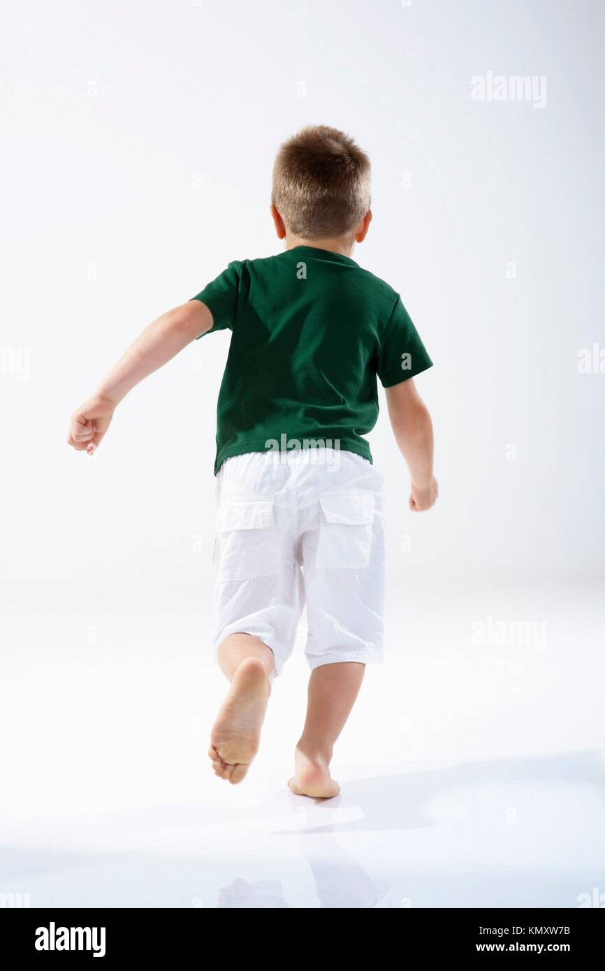 Rear view of a little boy running Stock Photo - Alamy