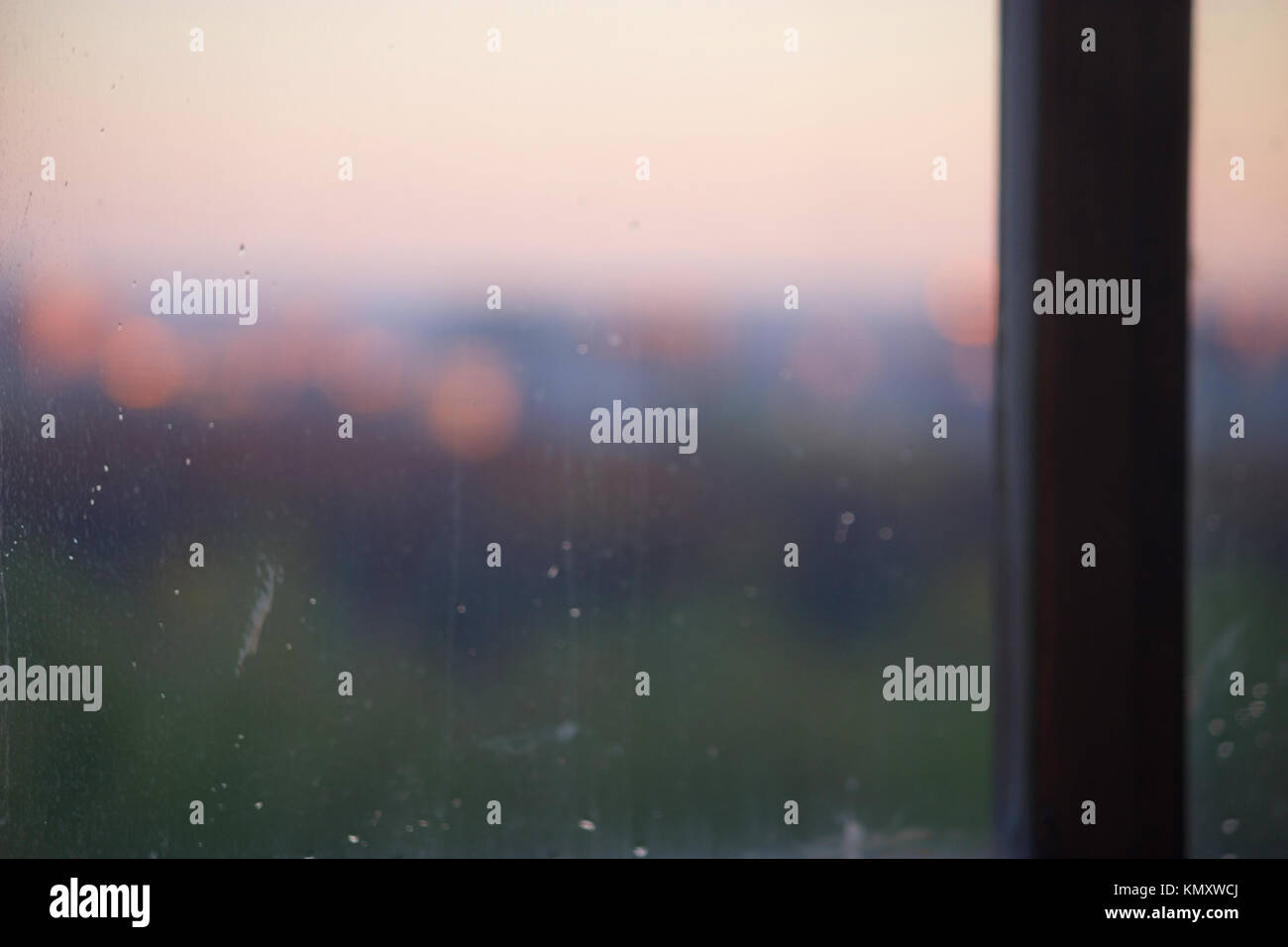 blurred image of a city through window. sunrise Stock Photo - Alamy