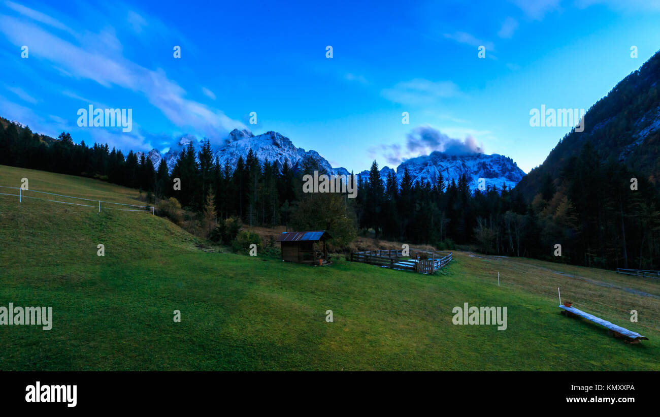 an alpine hut in the valley during a colorful sunset Stock Photo - Alamy