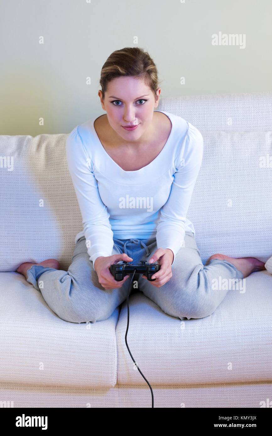 Young woman playing video games Stock Photo - Alamy