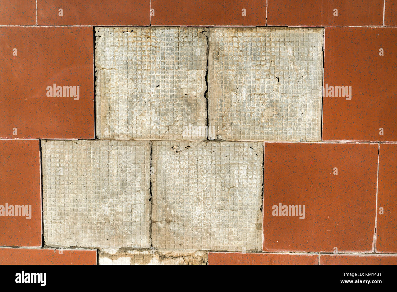 Wall with fallen tiles Stock Photo - Alamy