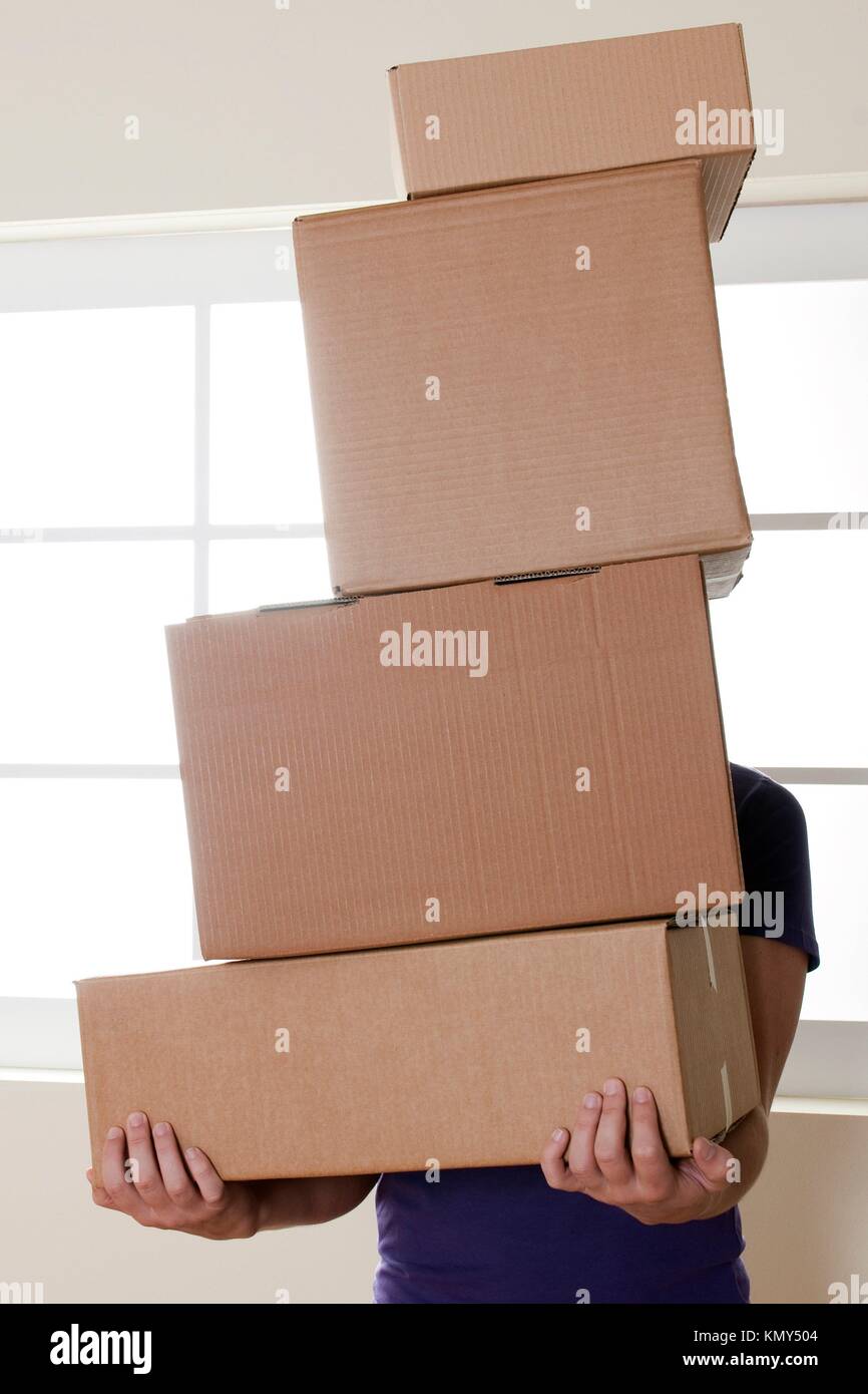 Man Carrying Stacked Boxes on moving day Stock Photo - Alamy