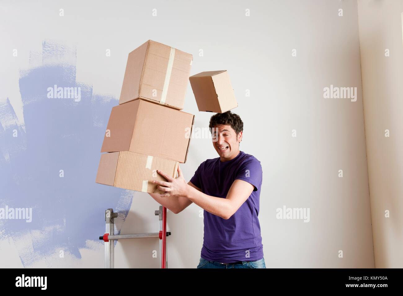 Man Carrying Stacked Boxes on moving day Stock Photo - Alamy